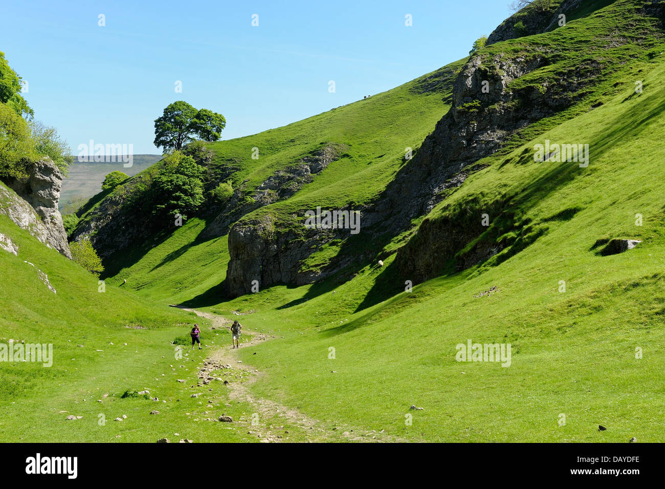 Two people in the distance walking through cave dale Castleton ...