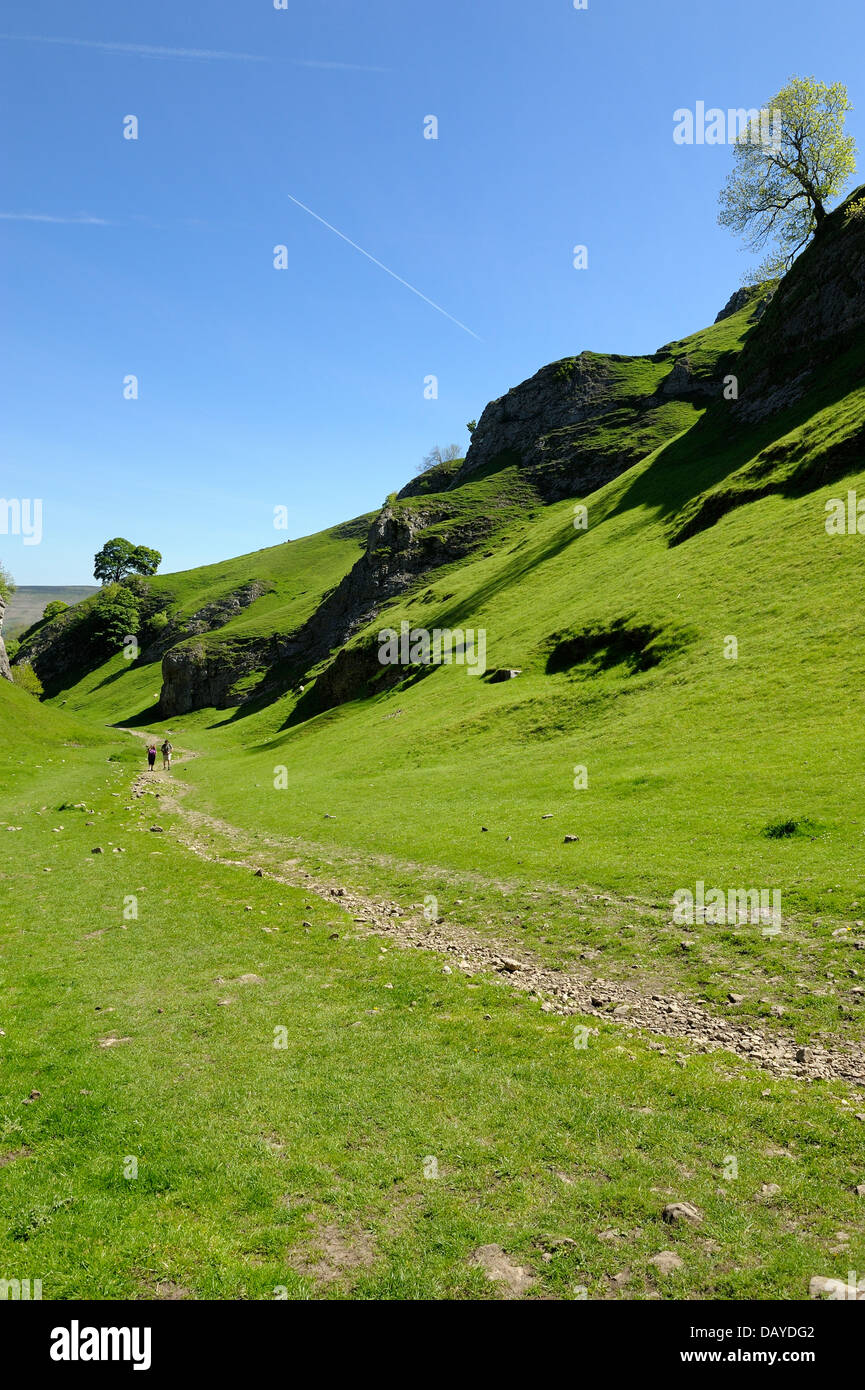 Two people in the distance walking through cave dale Castleton ...