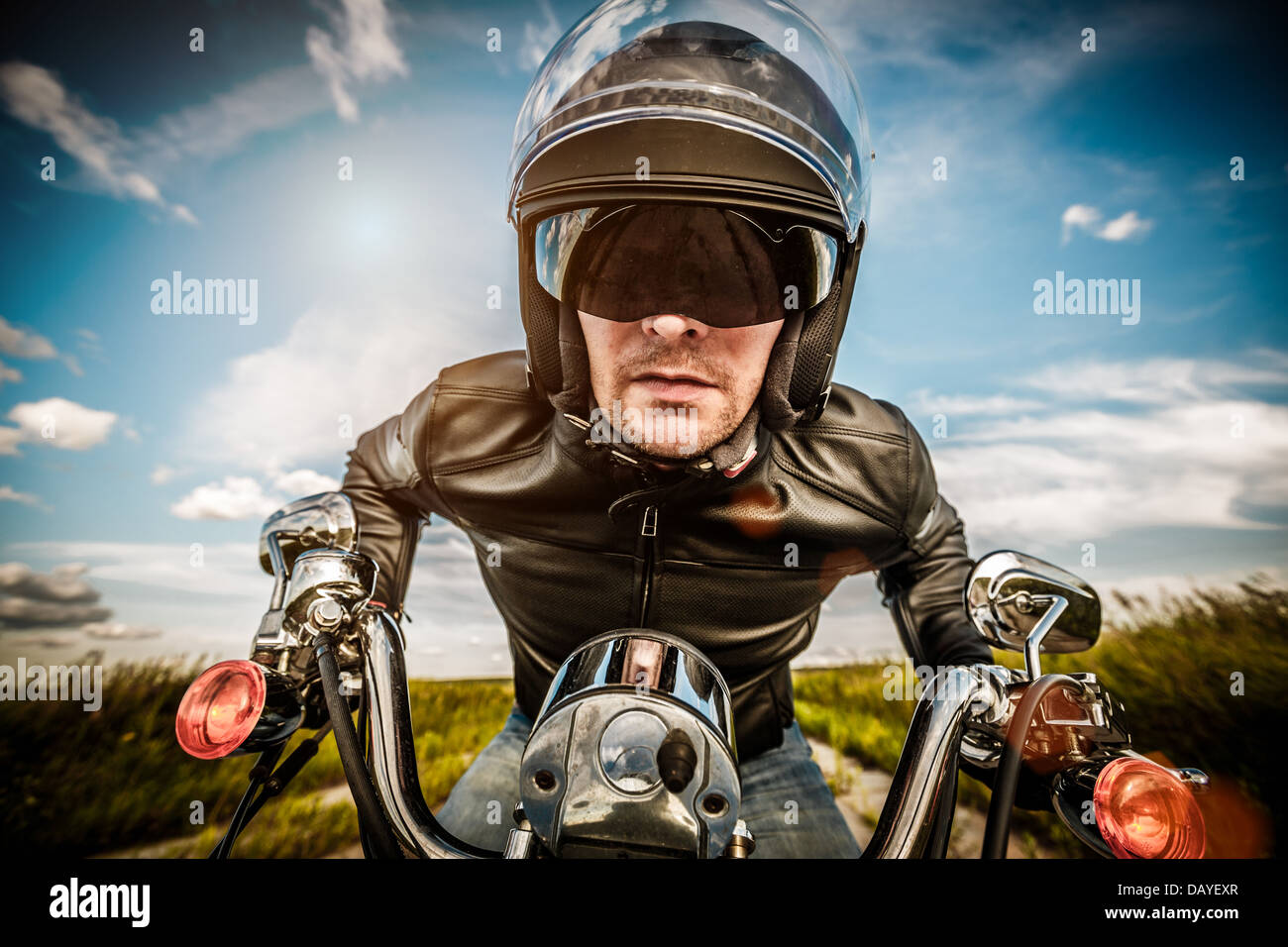 Biker in sunglasses and leather jacket racing on the road (fisheye lens ...