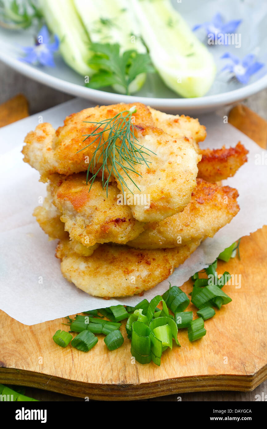 Stack of chicken cutlet on a wooden cutting board Stock Photo - Alamy