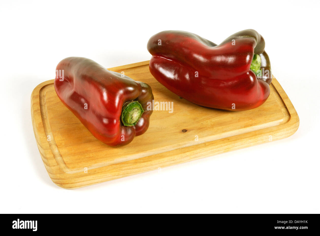 Two red peppers on a table Stock Photo - Alamy
