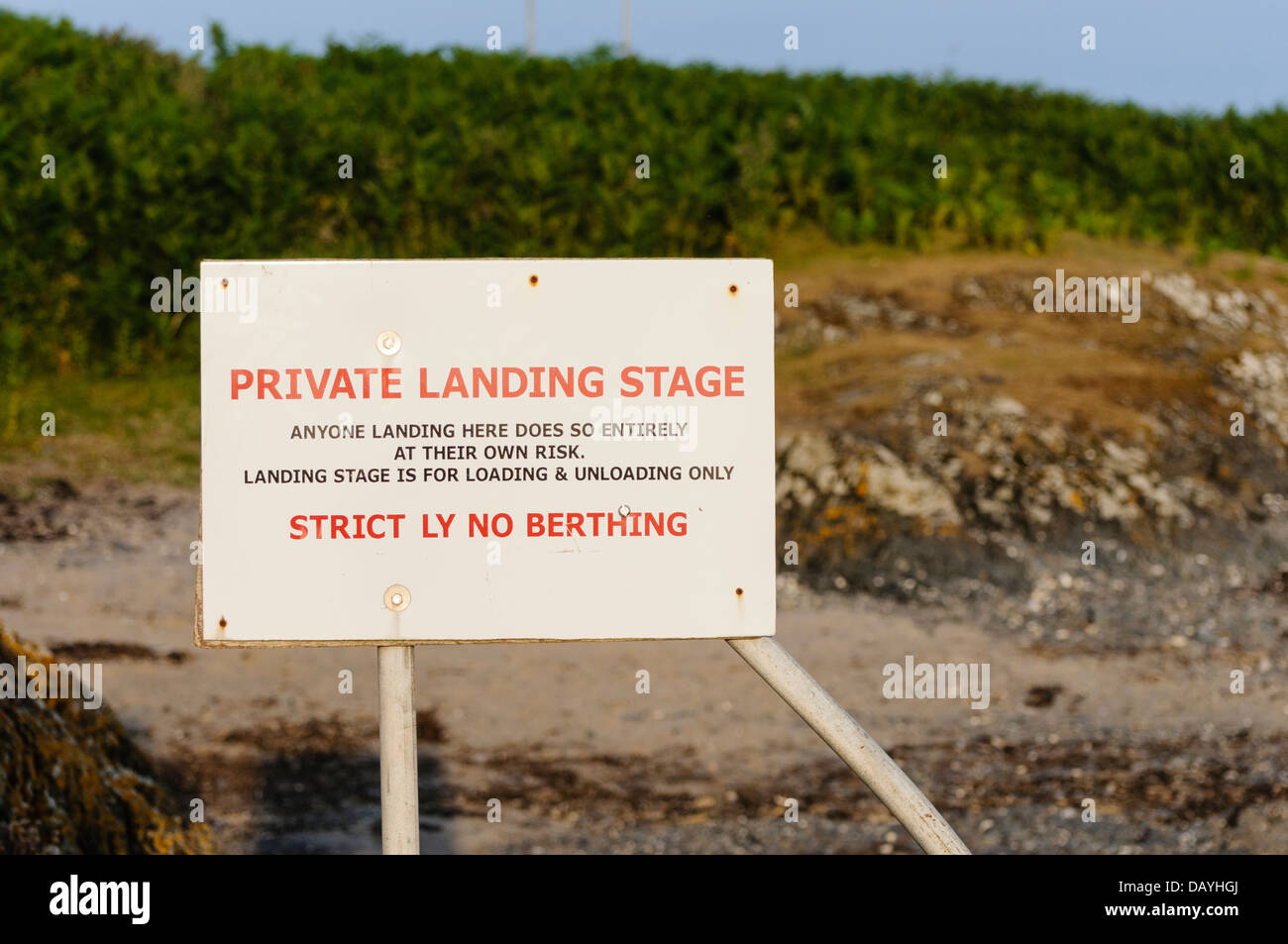 Sign warning visitors about a private landing stage on a rocky shore ...
