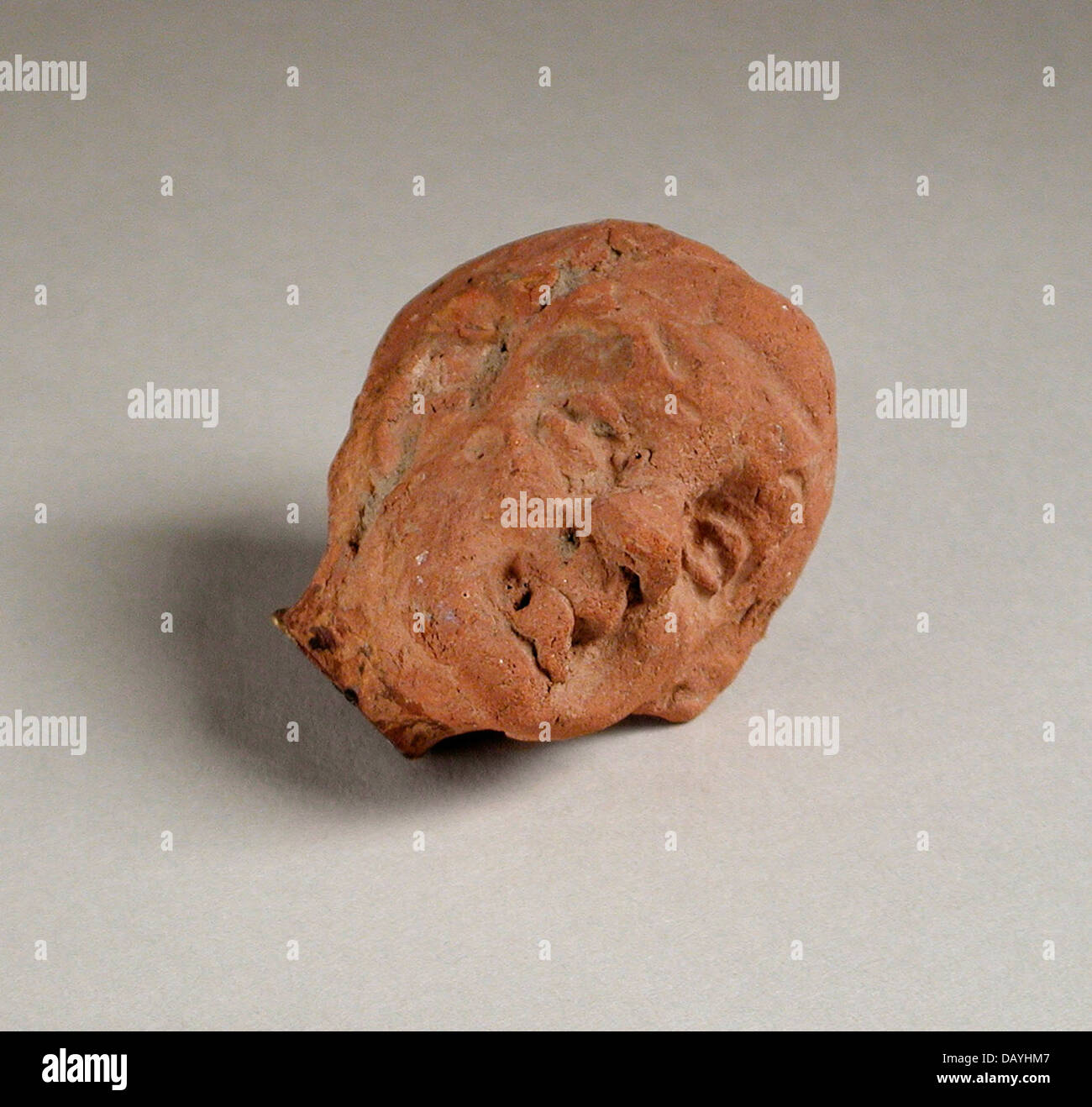 This sculpted human head is an example of ancient portraiture, possibly ...