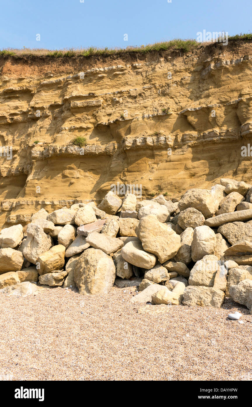Pile of fallen rocks below eroded sandstone cliff at Freshwater Bay ...