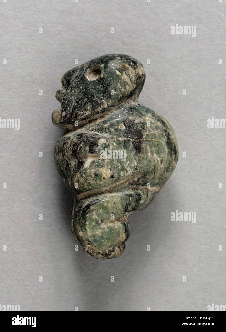 A sculpture of a hunchback figure, likely a character from folklore or ...