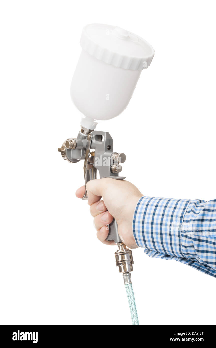A painter's arm hand holding industrial size spray gun used for ...