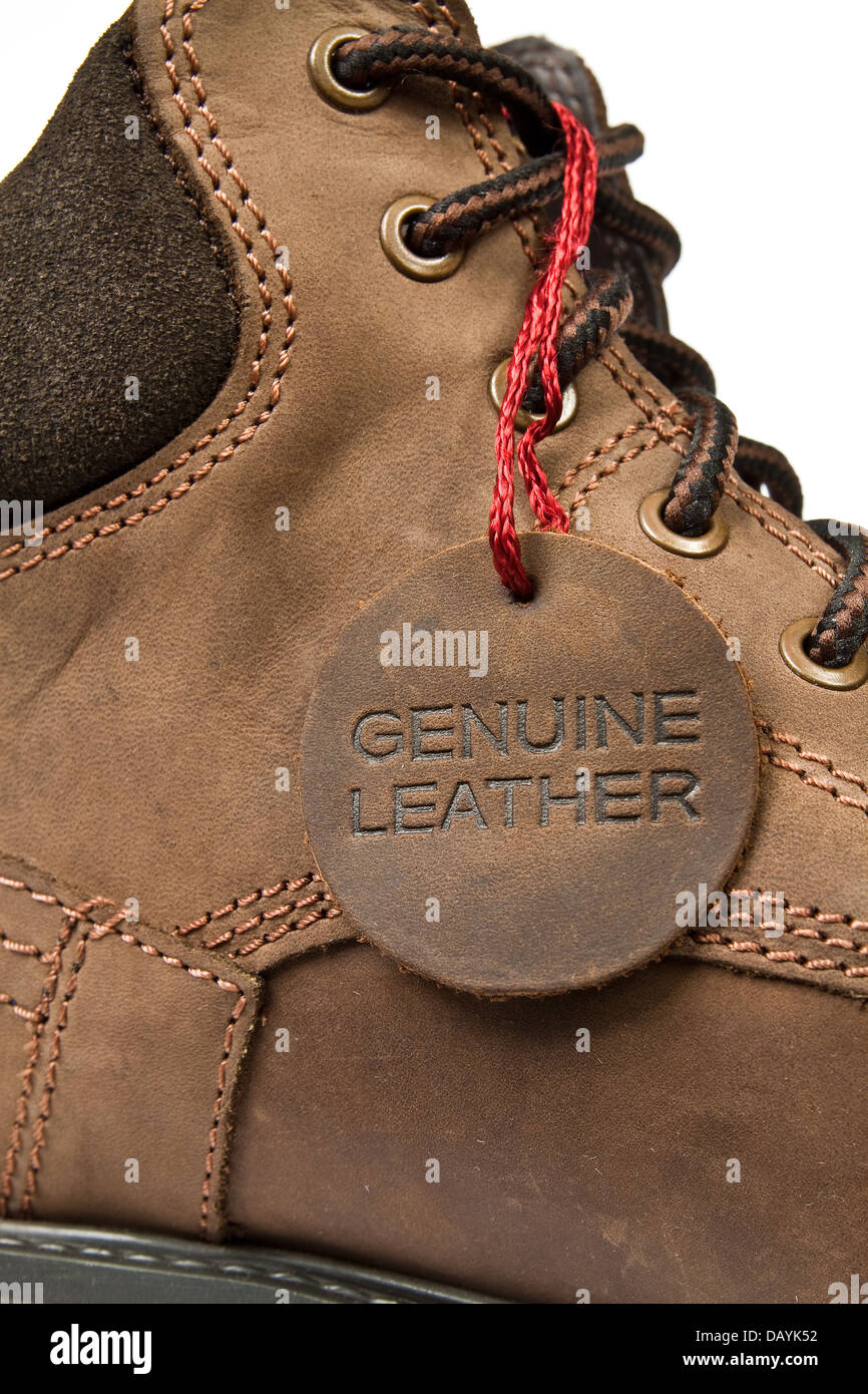 Mens brown leather boots with a red label strings Stock Photo - Alamy