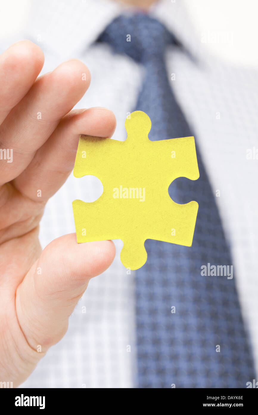 Male holding puzzle piece in one hand Stock Photo - Alamy