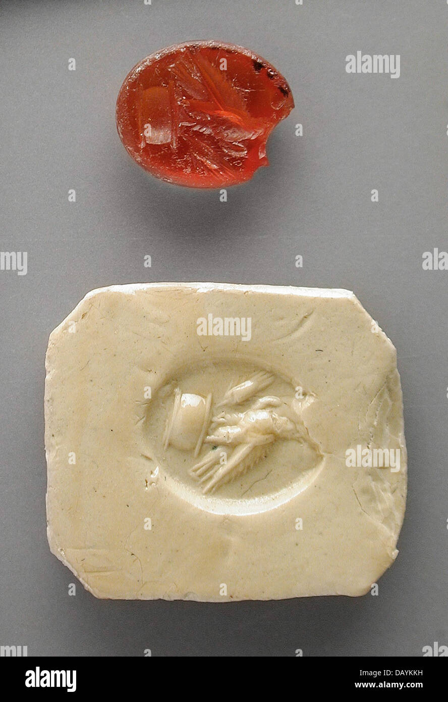 This intaglio is a carved gem featuring detailed, incised designs. It ...