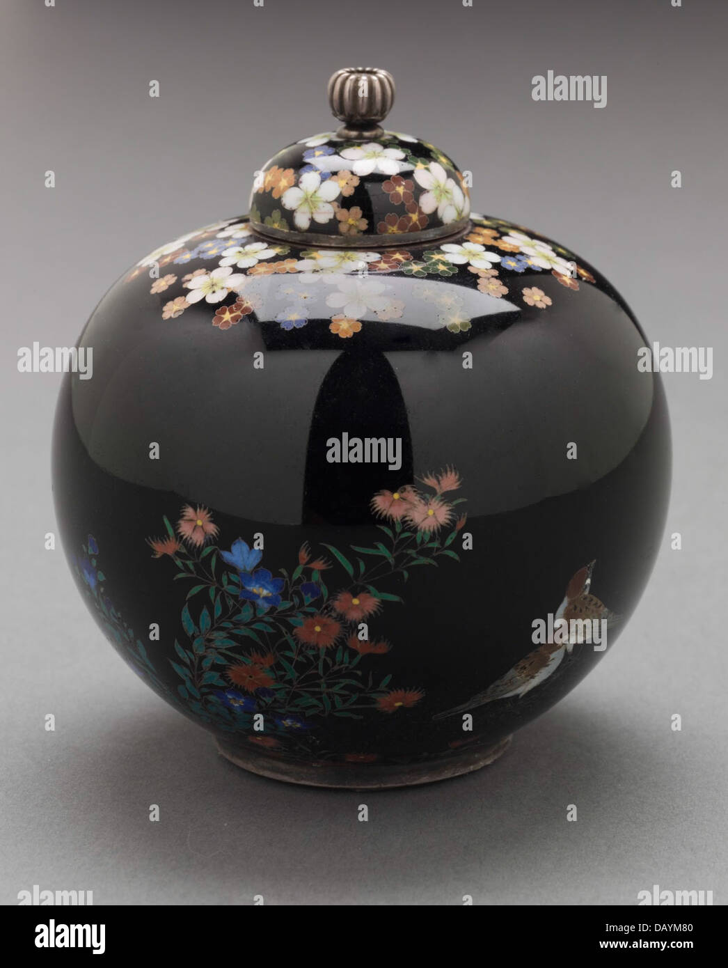 A bronze jar with a cover, featuring ornate detailing and representing ...