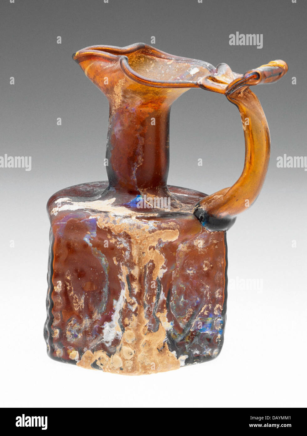 This jug features Jewish symbols and is made of earthenware. The vessel ...