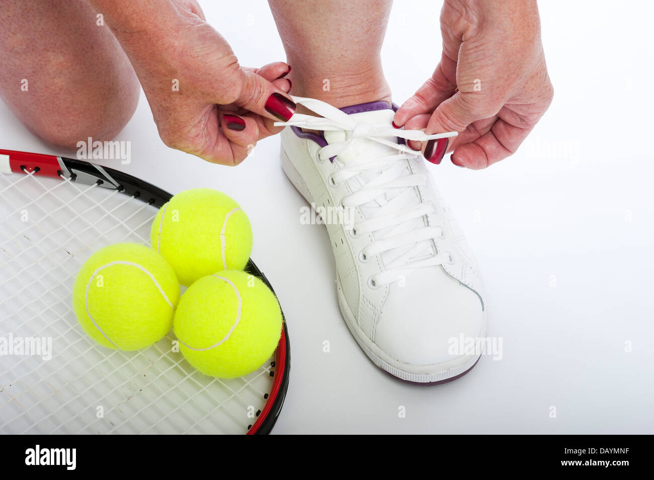 Female tennis player tying shoe laces Stock Photo - Alamy