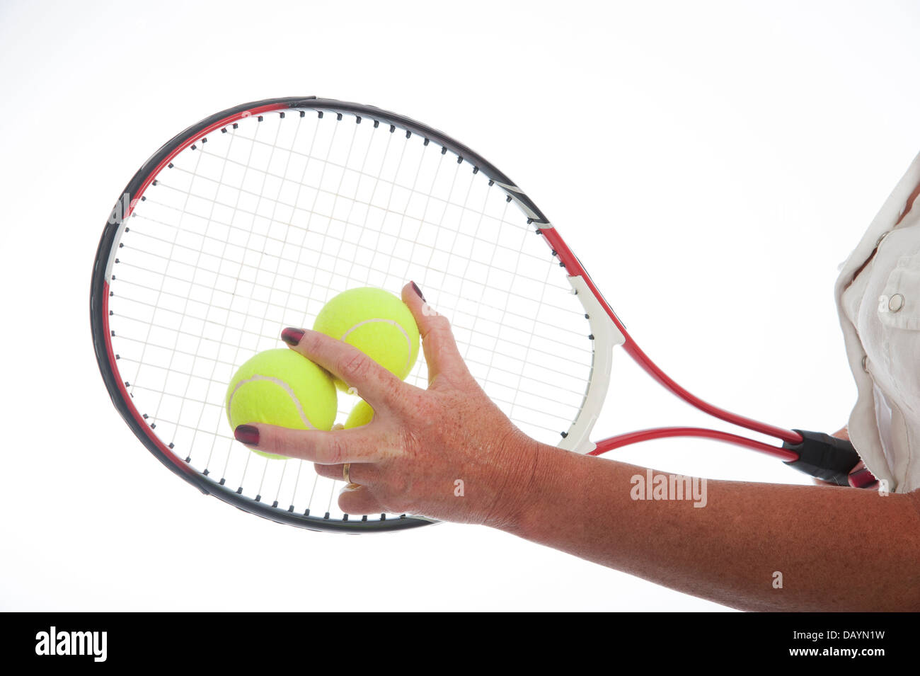 Female tennis player holding tennis ball and racquet Stock Photo - Alamy