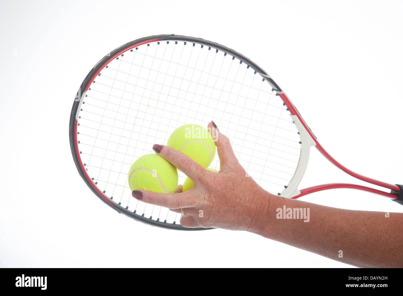 Female tennis player holding tennis ball and racquet Stock Photo - Alamy