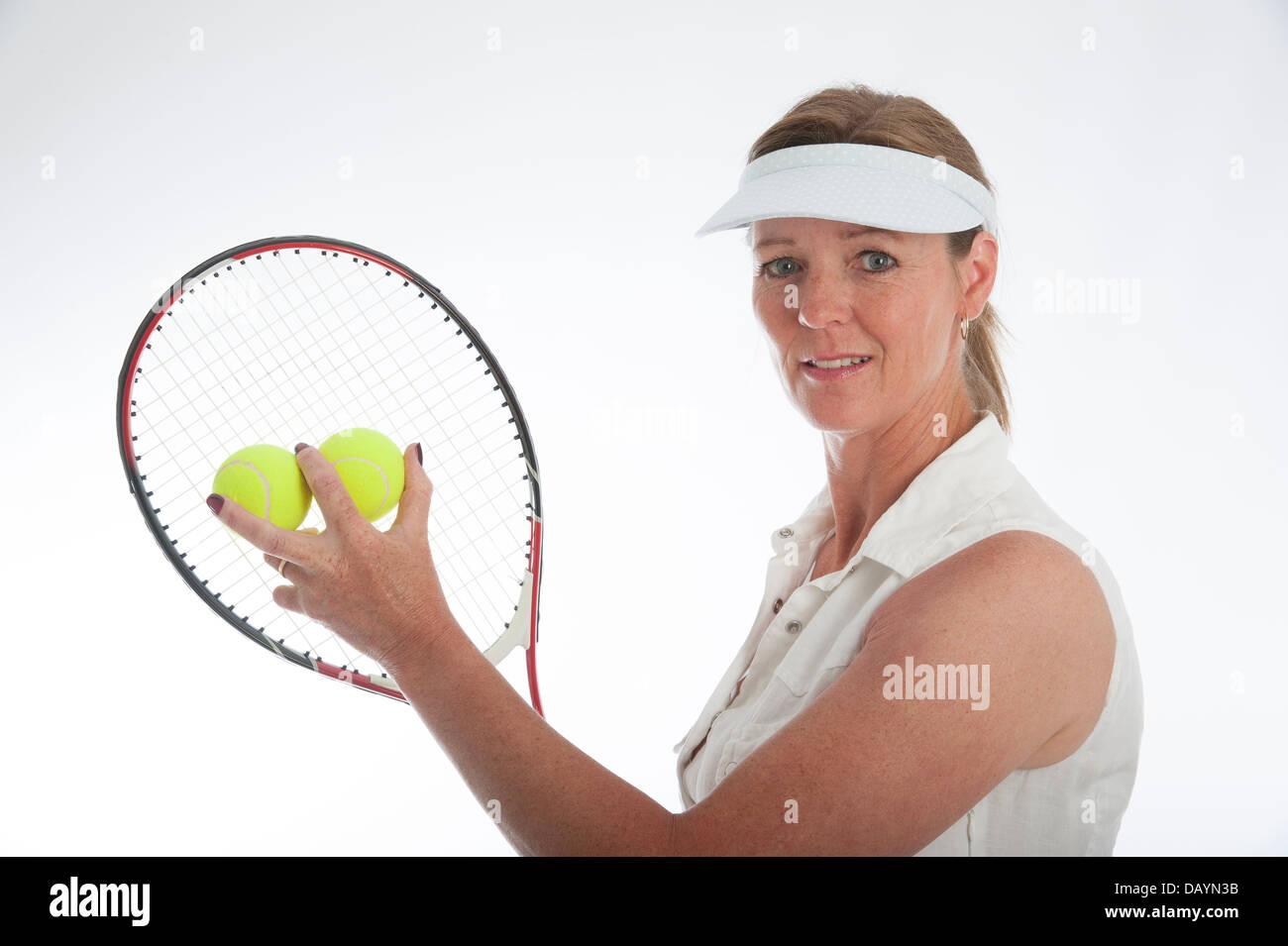 Female tennis player holding tennis ball and racquet Stock Photo - Alamy