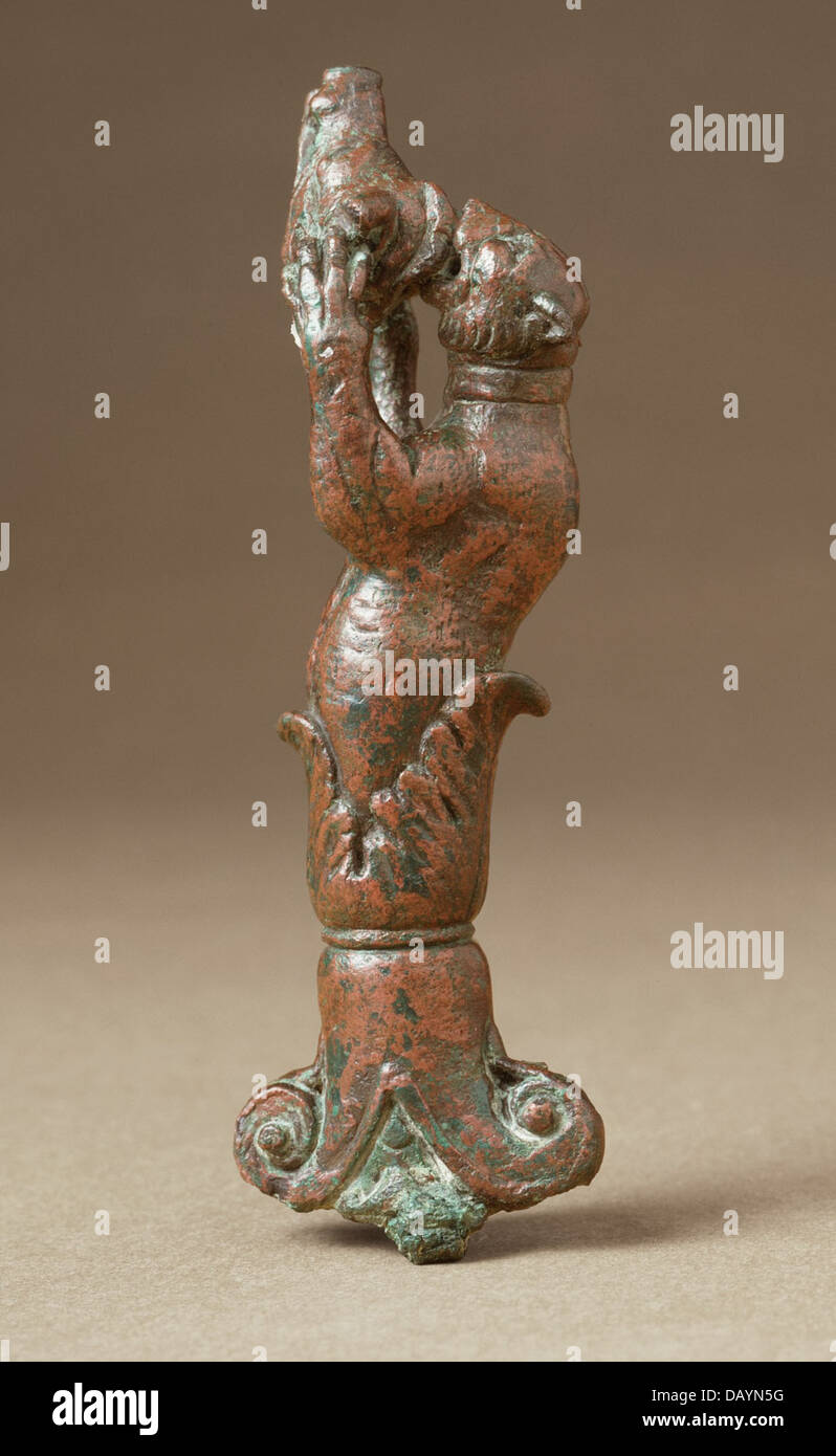 This knife handle features a dynamic carving of a lioness devouring a ...