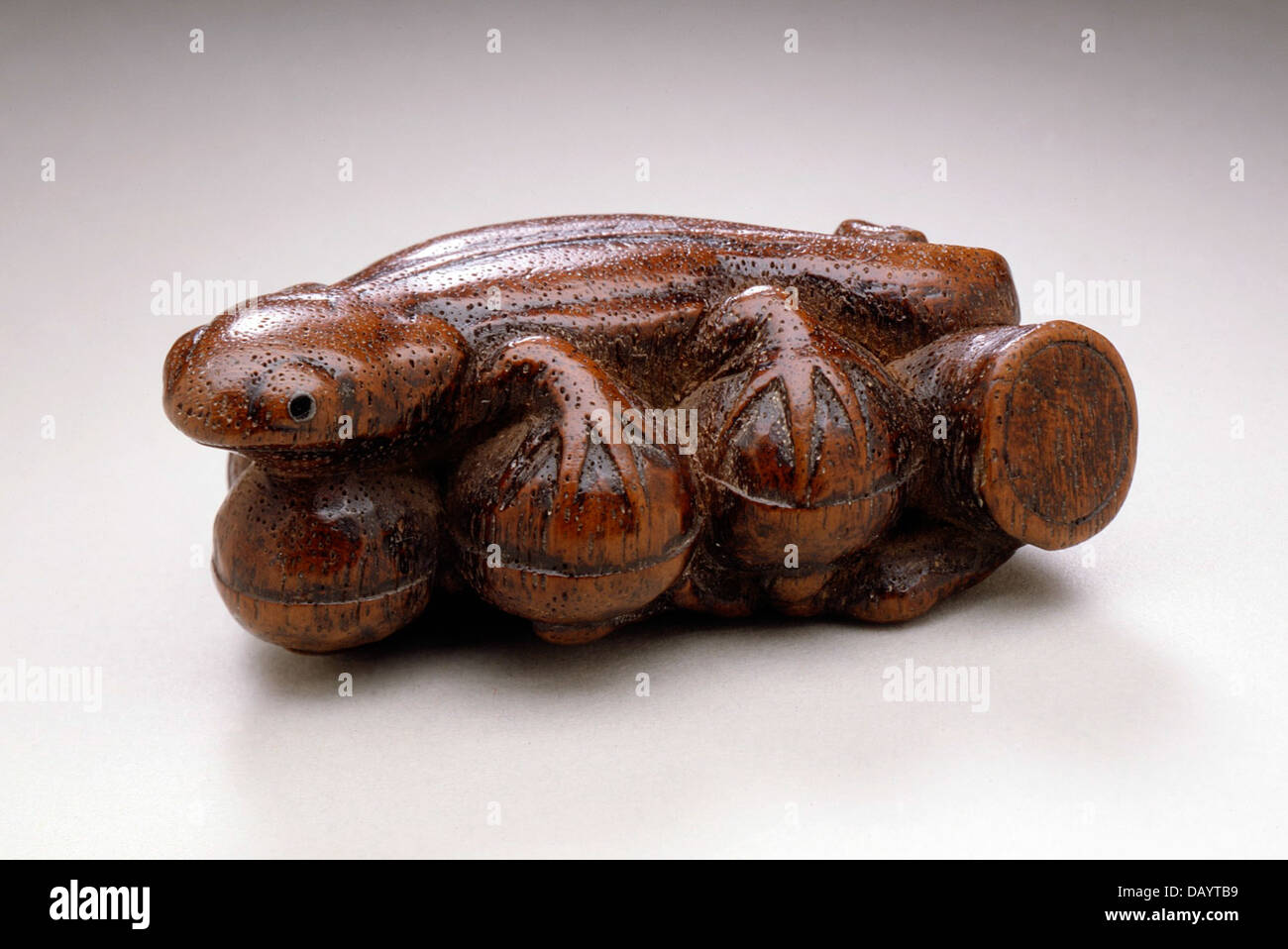 This bronze sculpture features a detailed lizard perched on an acorn ...