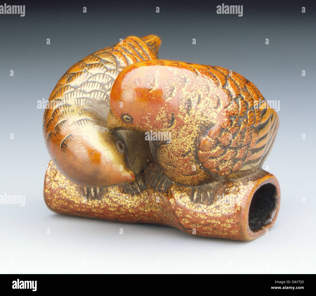 This sculpture, titled 'Love Birds,' portrays two birds in a loving ...