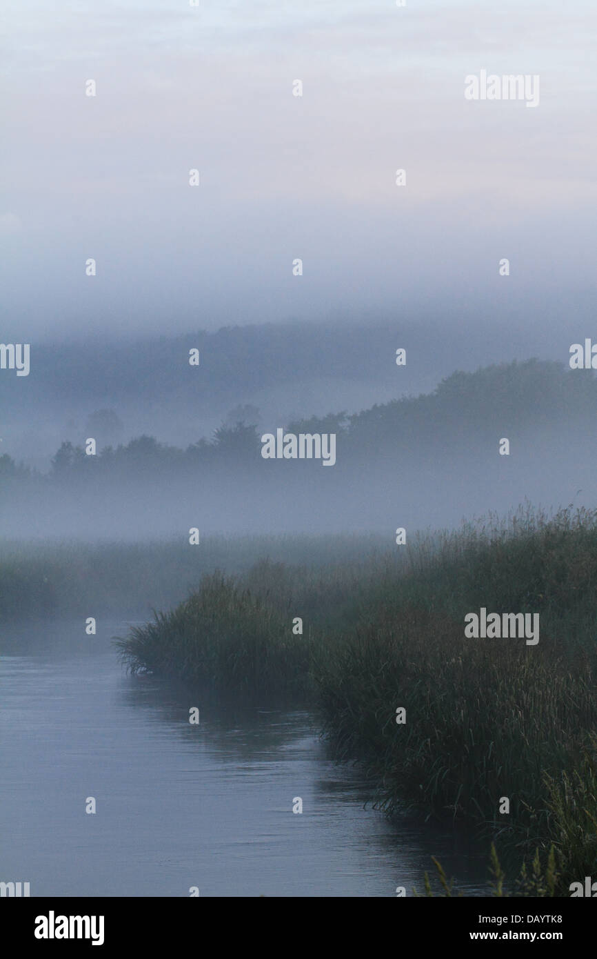 Dense fog and the danish river Vejle Å just before sunrise ...