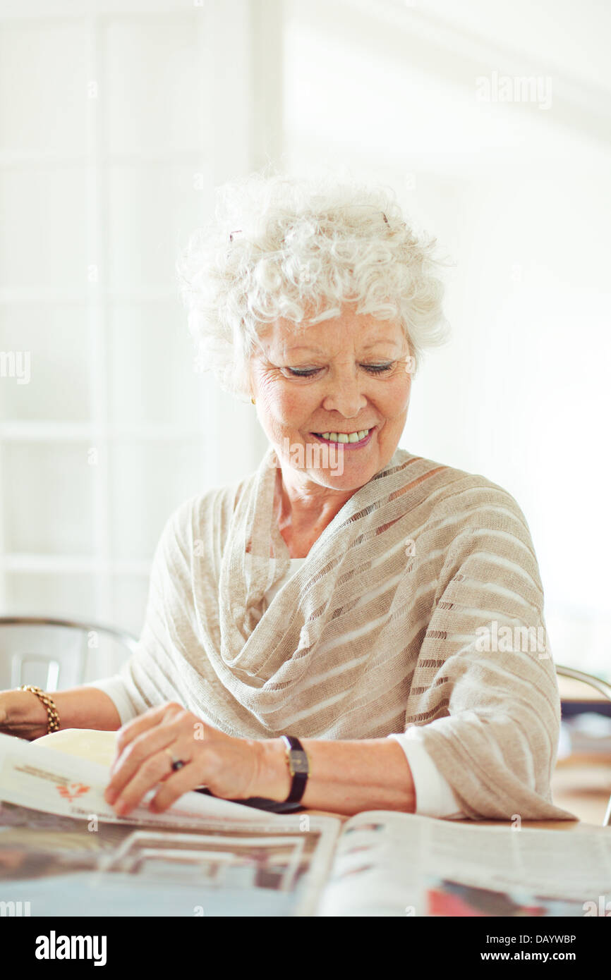 Mature woman reading indoor alone hi-res stock photography and images ...