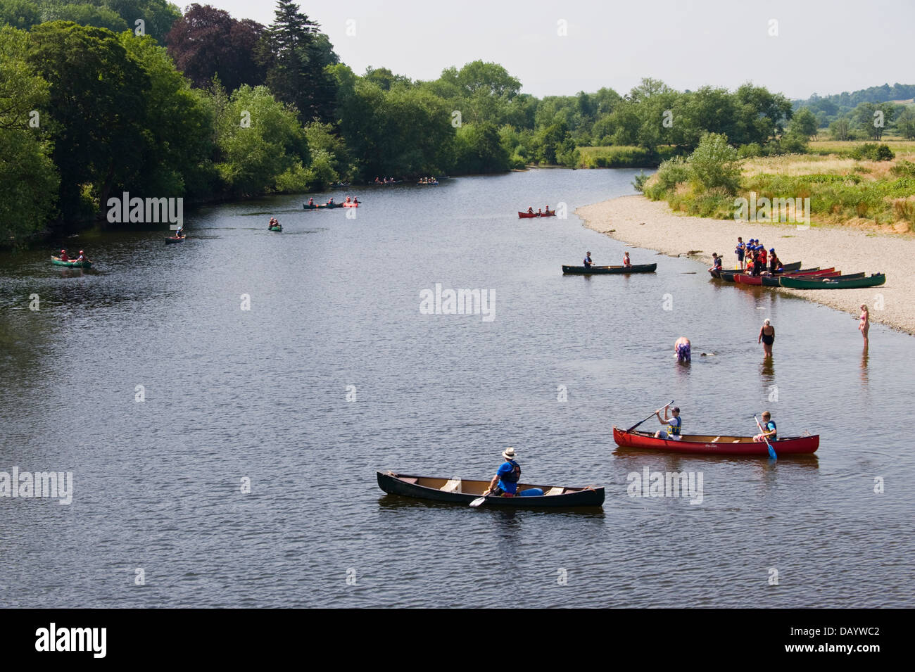 Children & adults in open canoes practice their canoe skills before ...