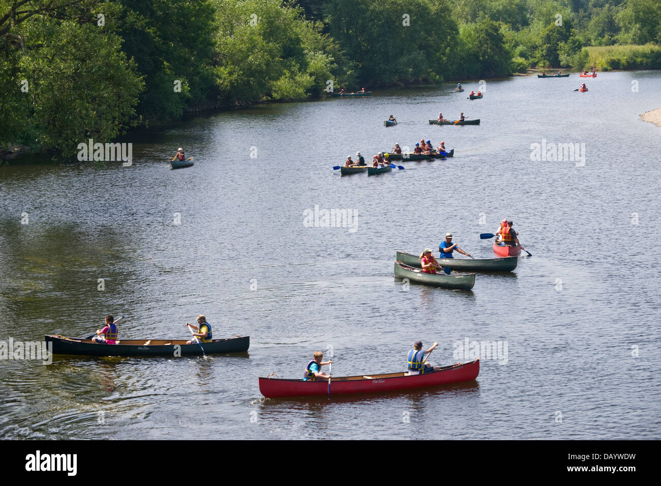 Children & adults in open canoes practice their canoe skills before ...