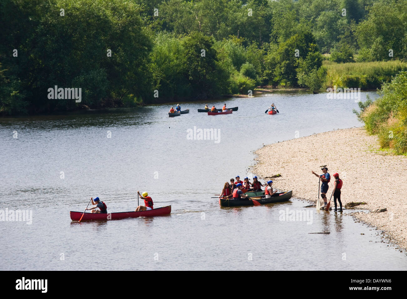 Children & adults in open canoes practice their canoe skills before ...