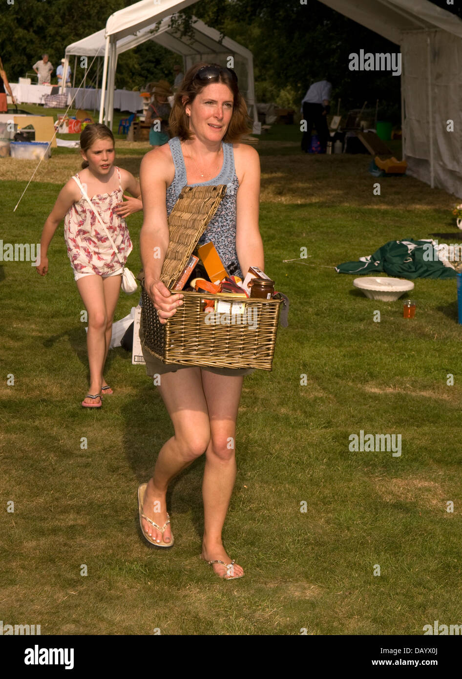 Woman carrying some of the remains of her stall to car at end of ...