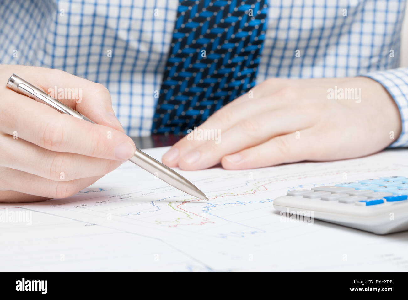 Business man doing calculations at the desk Stock Photo - Alamy