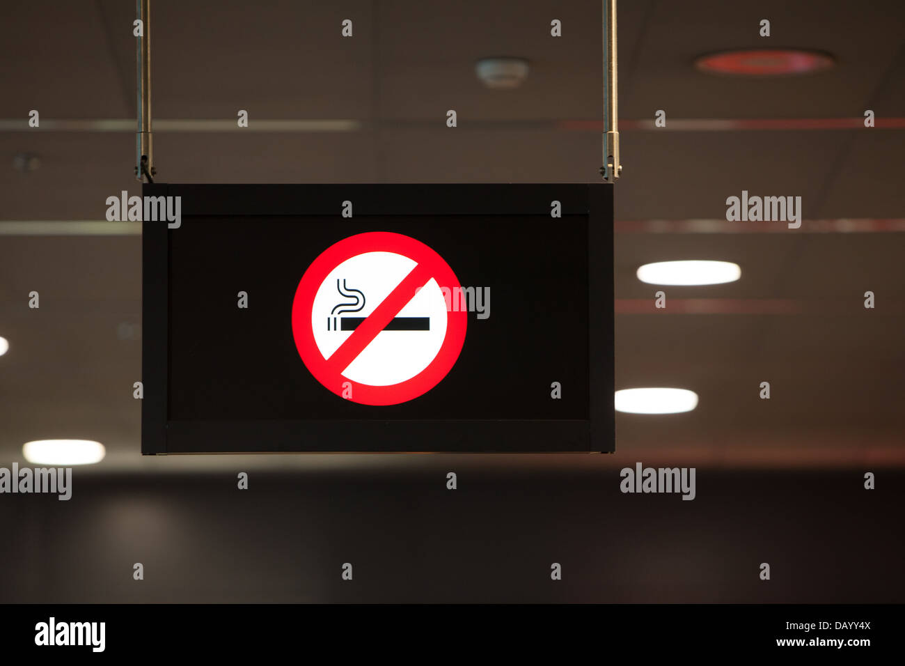 A black, illuminated non smoking sign with a red "smoking not permitted ...