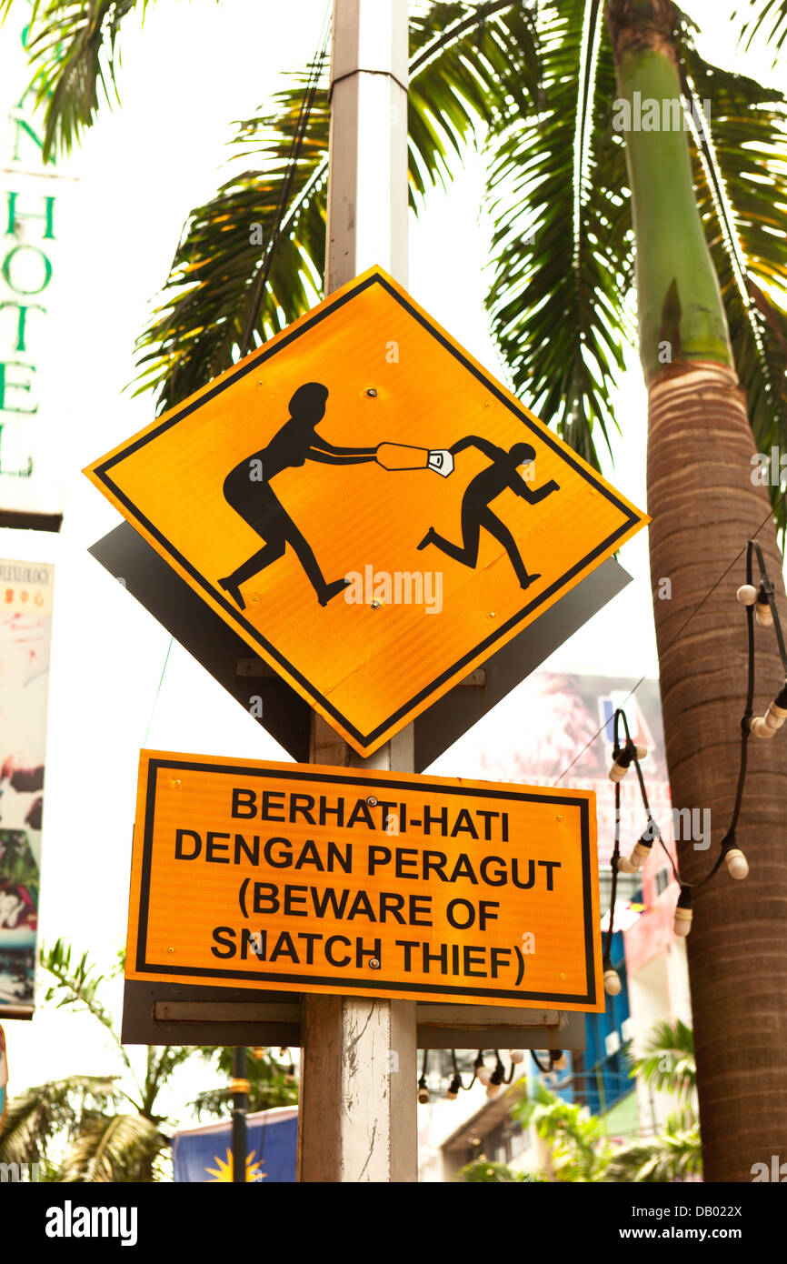 Warning sign against handbag theft on Jalan Bukit Bintang Stock Photo ...