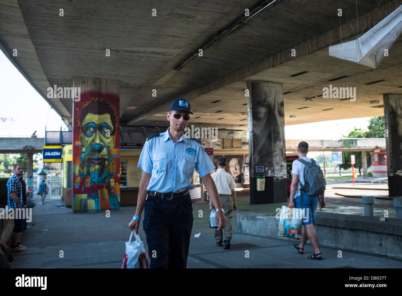 security guard with a bag under a bridge Stock Photo - Alamy