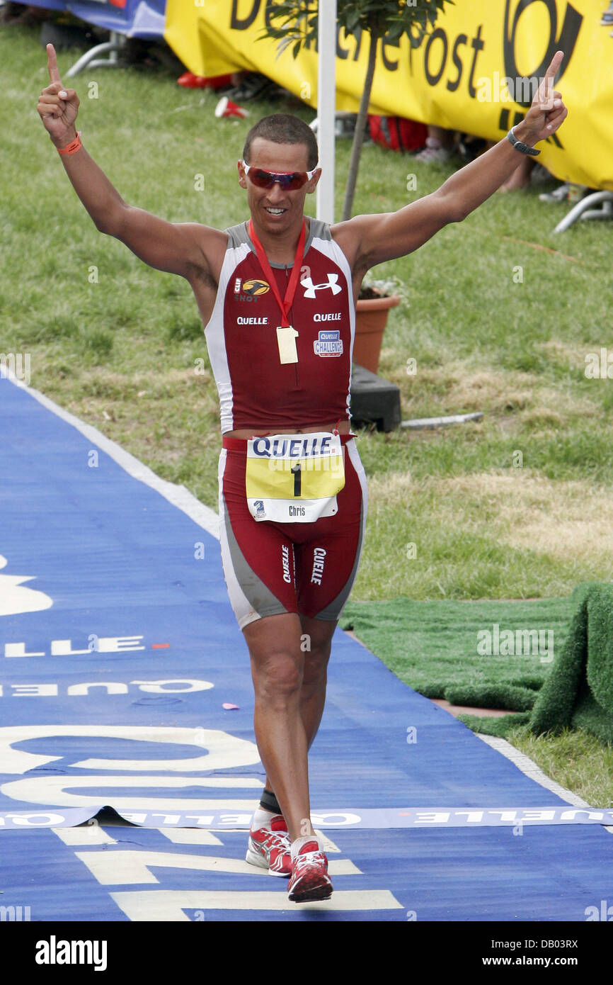 Australian triathlete Chris McCormack arrives first in the finish of ...