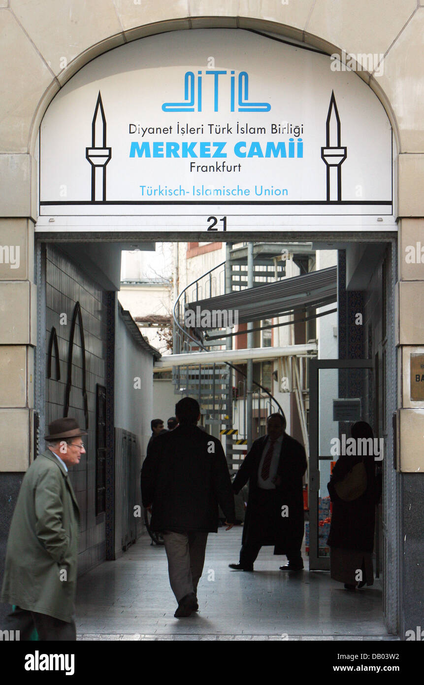 Muslims are pictured at the entrance of a mosque of the Turkish-Islamic ...