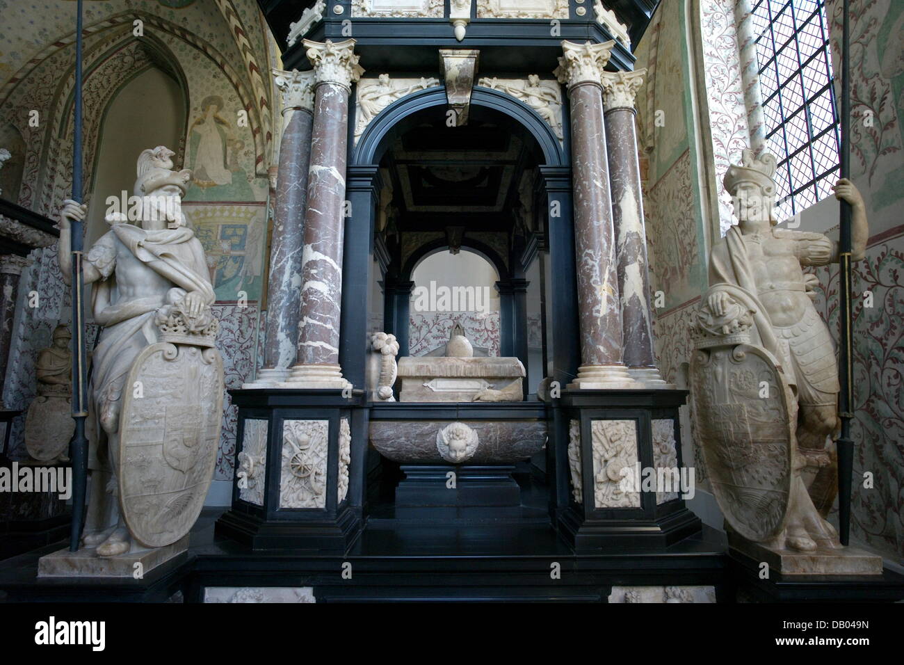 The photo shows a richly ornated tomb inside Roskilde cathedral ...