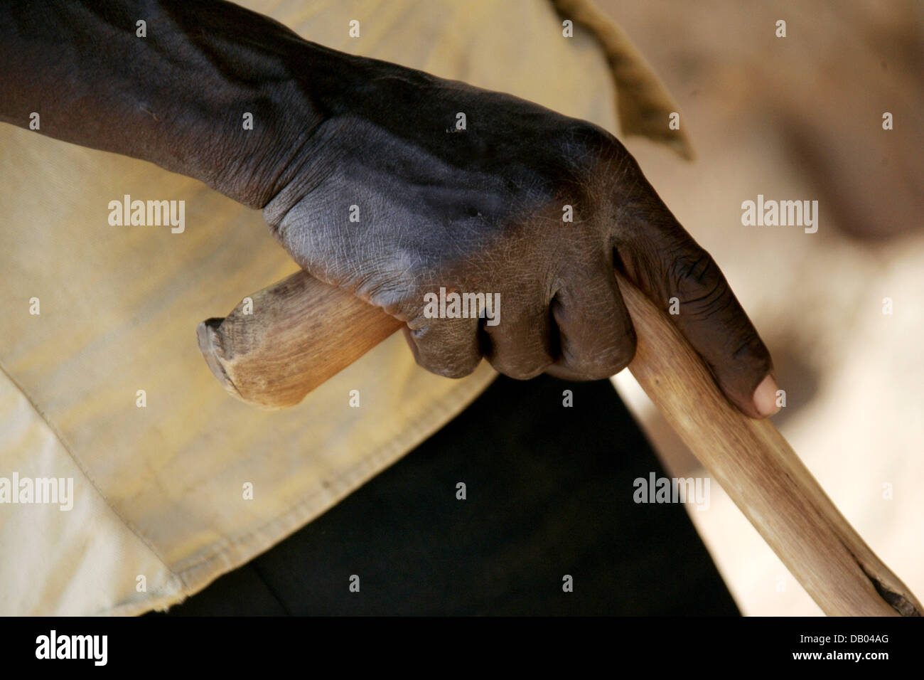 An old man holds a wooden walking stick at refugee camp Pabbo near Gulu ...