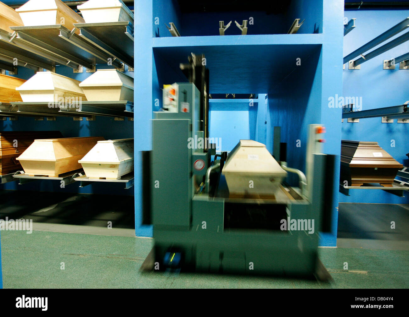 An unmanned carrier vehicle transports a coffin from the cooled storage ...