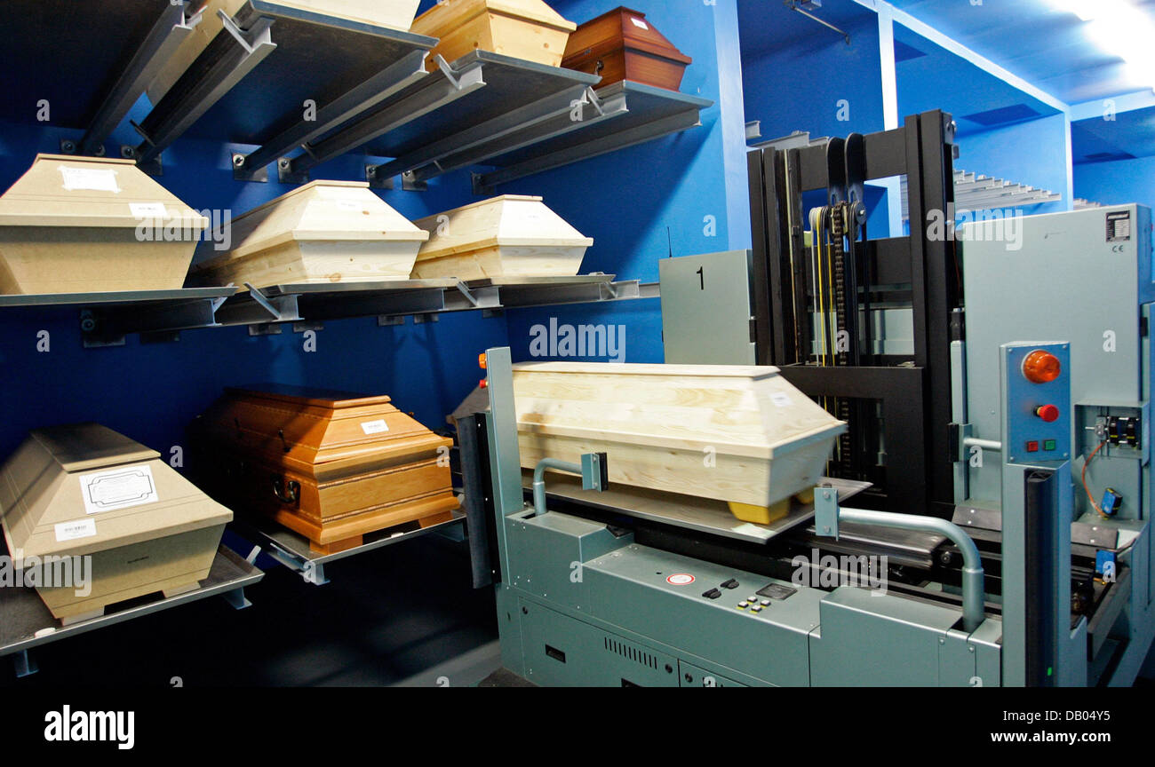 An unmanned carrier vehicle transports a coffin from the cooled storage ...