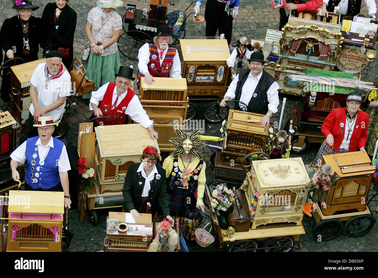 Several barrel organ players play their instruments in Laubach, Germany ...