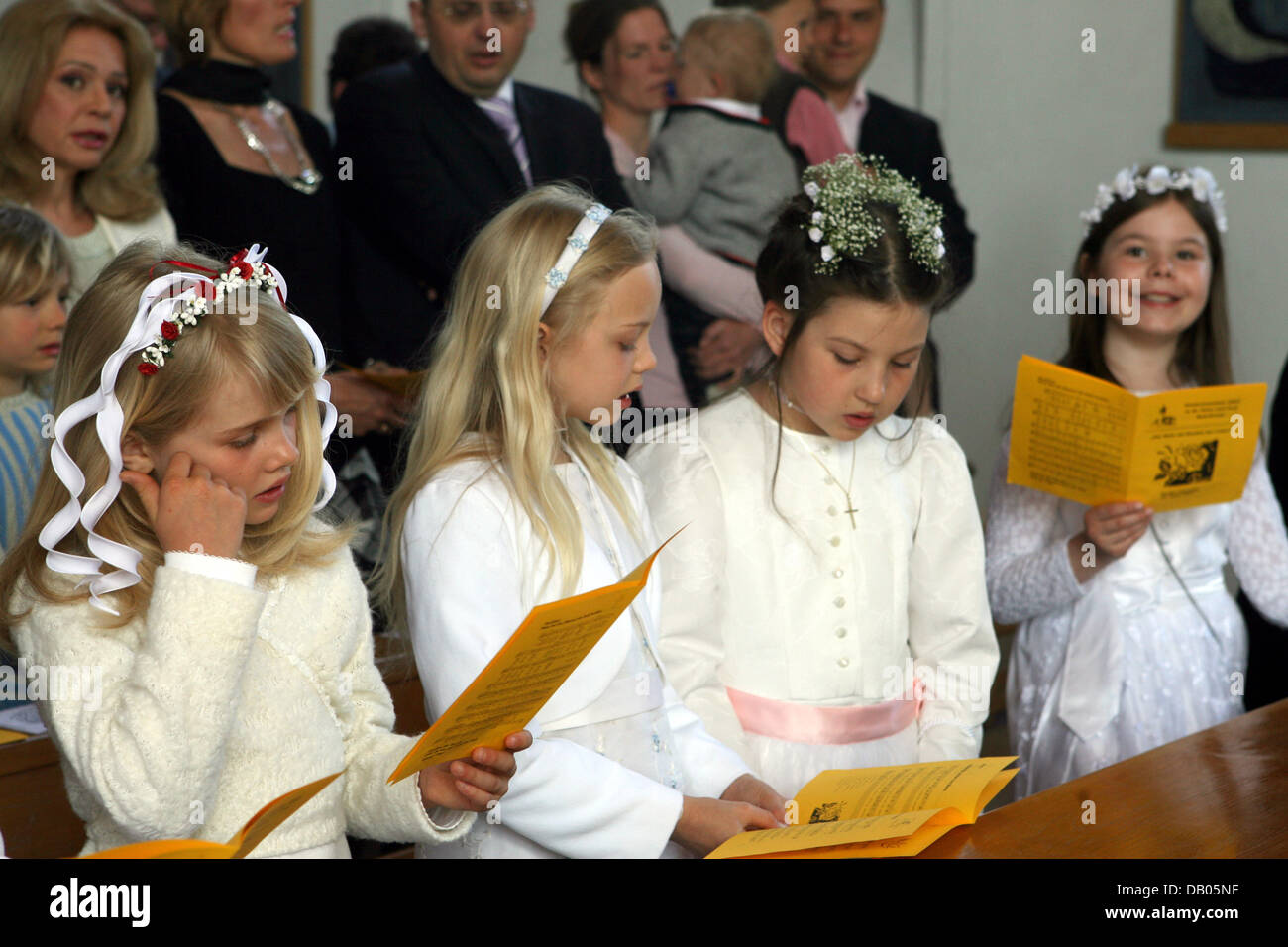 Girls shown sing during the First Communion ceremony at Catholic Saint ...