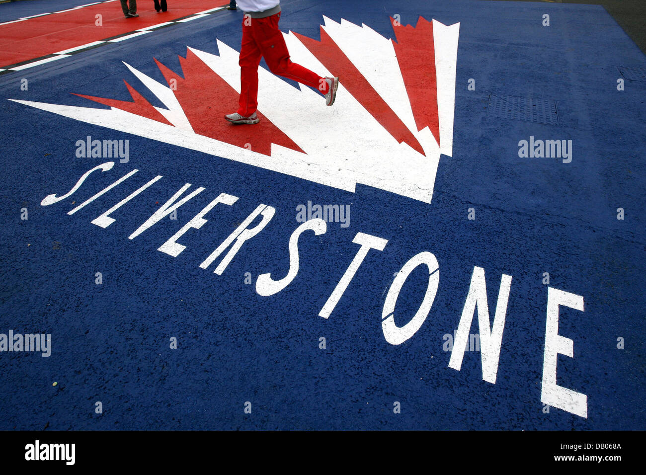A team members walks over the Silverstone logo on the ground of the ...
