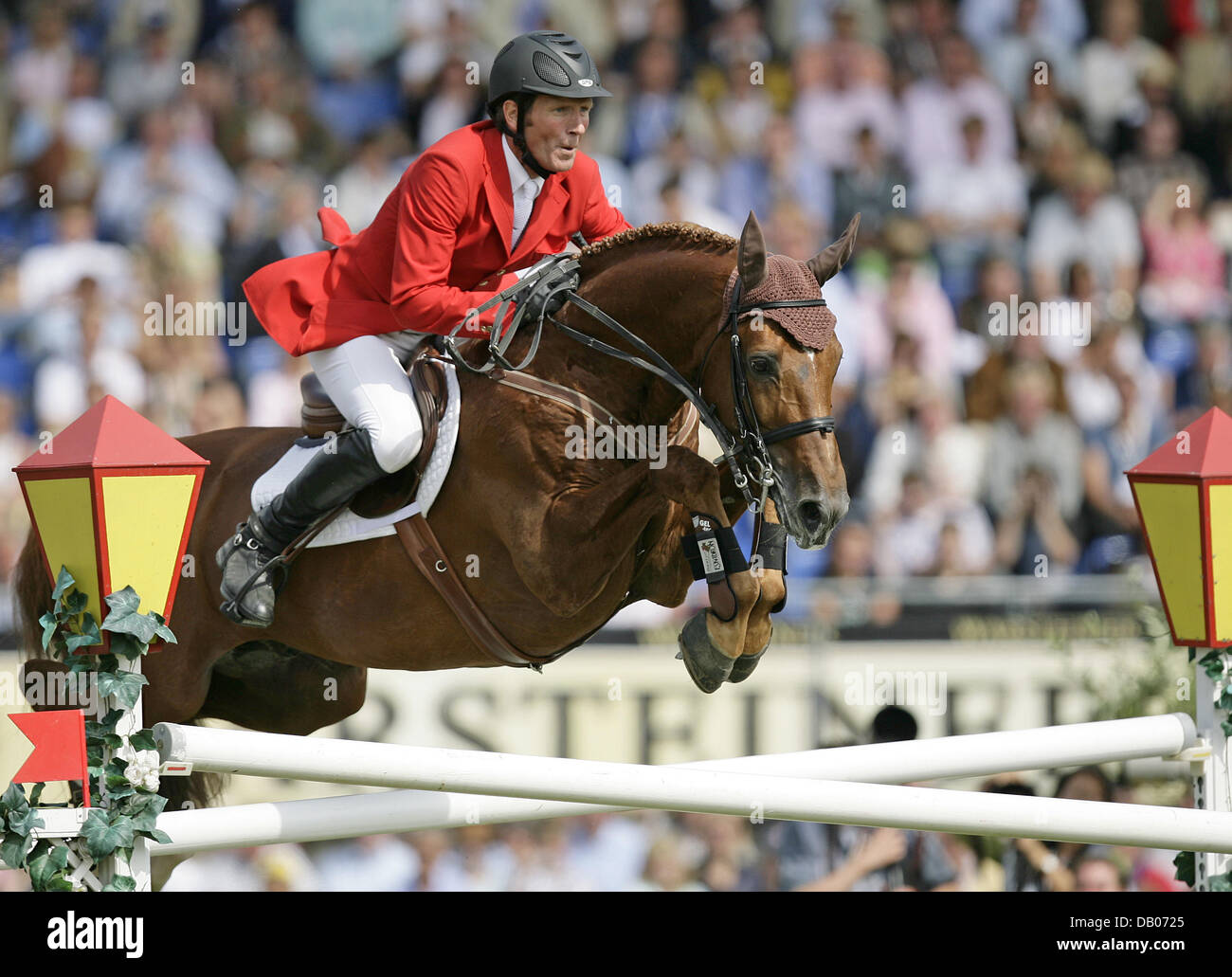 German equestrian Ludger Beerbaum and his horse 'Goldfever' take an ...