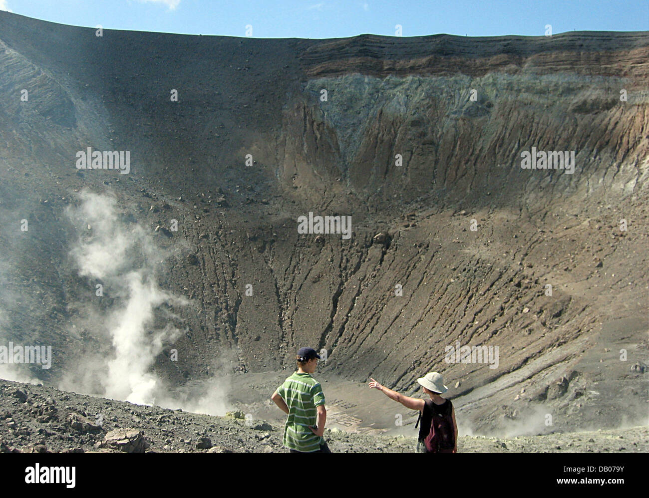 Tourists observe the crater of Vulcano Gran Cratere on Aeolian Island ...