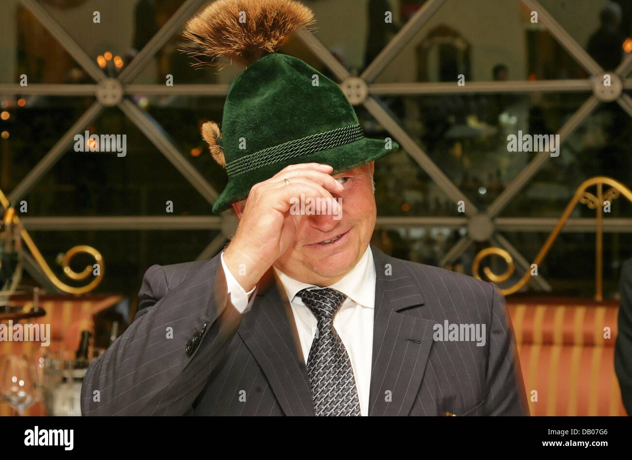 Mayor of Moscow, Yuriy Luzhkov, puts on a traditional Bavarian green ...