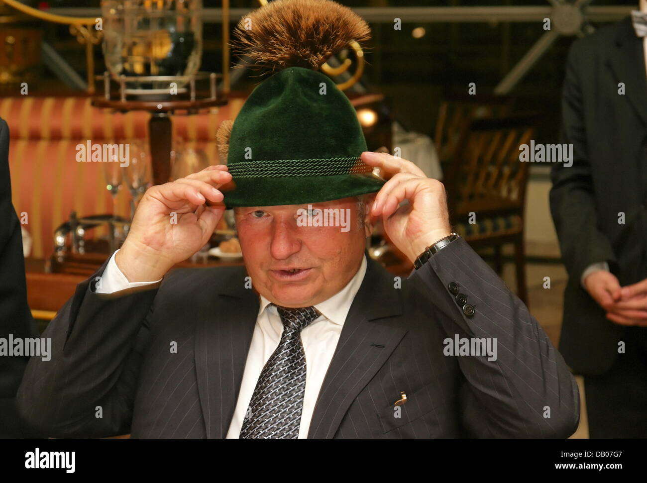 Mayor of Moscow, Yuriy Luzhkov, puts on a traditional Bavarian green ...