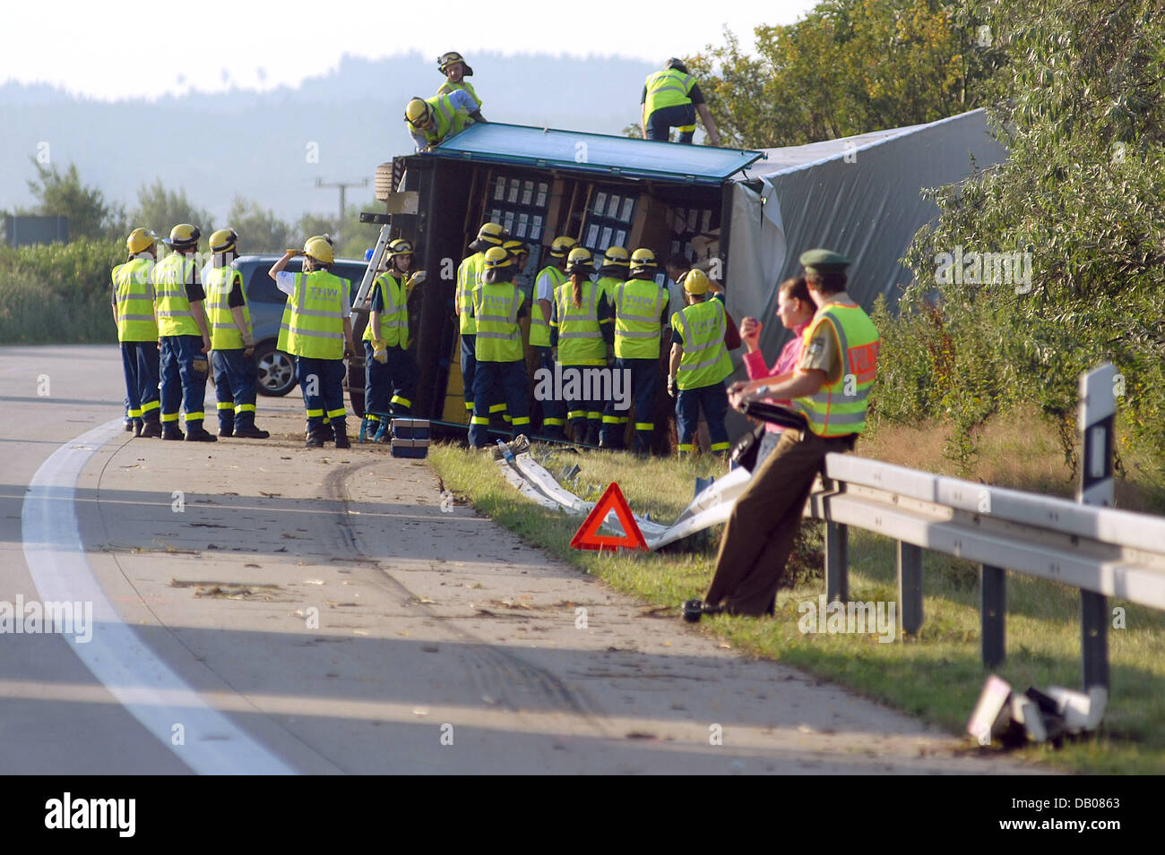 A rescue team recovers a tipped over lorry at a lay-by on the motorway ...