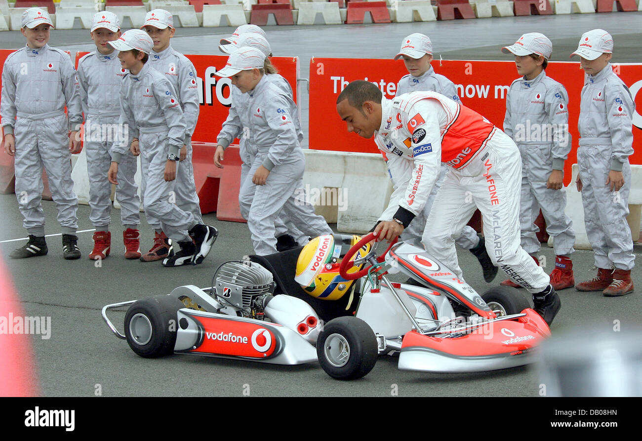 British Formula One pilot Lewis Hamilton of McLaren Mercedes pushes his ...
