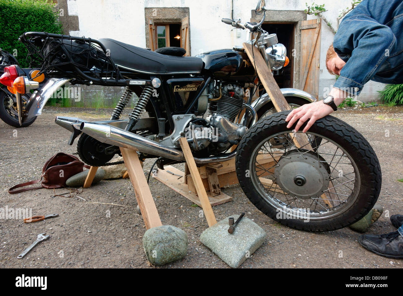 Man repairing old Motorbike with homemade stand Stock Photo - Alamy