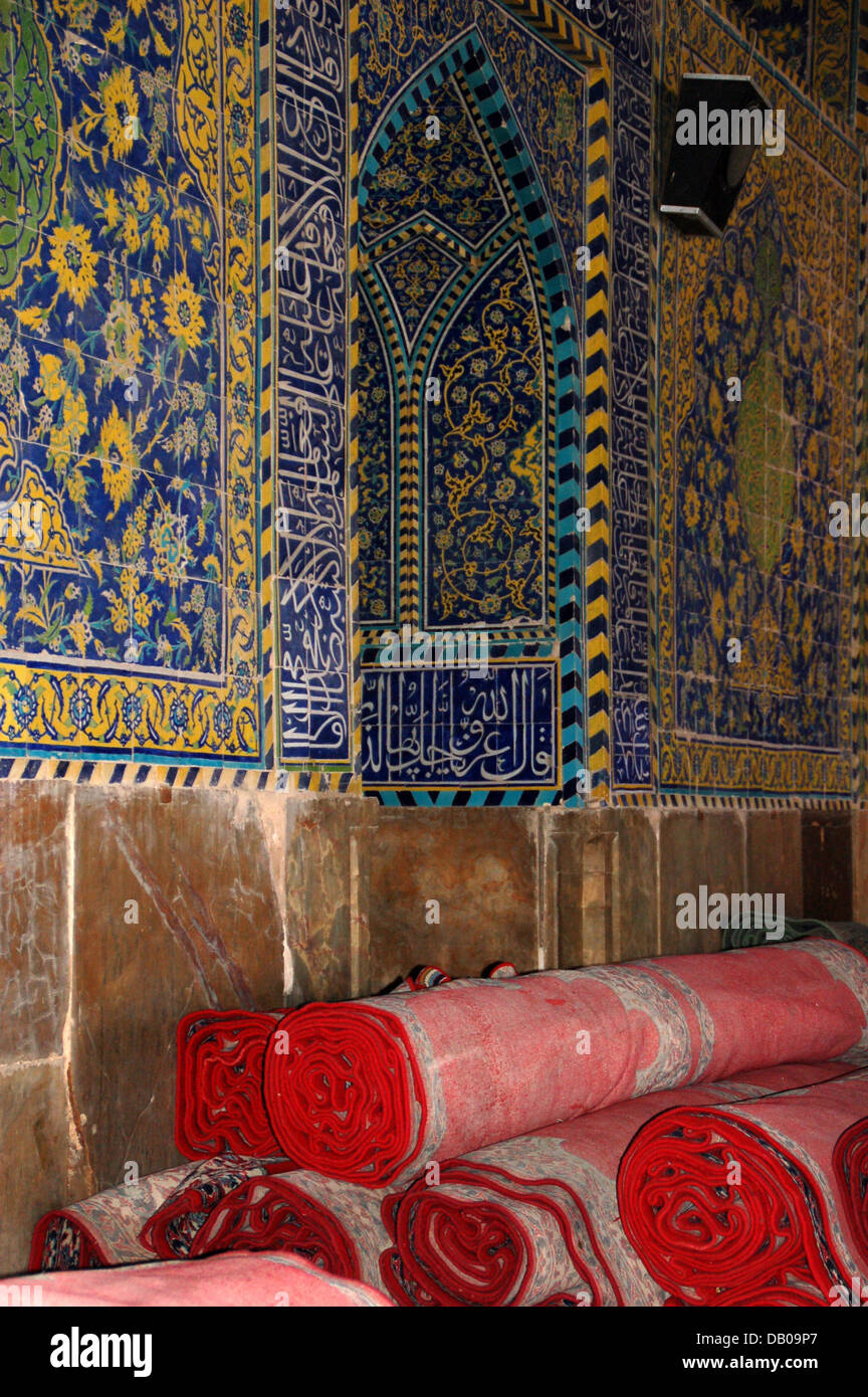 The picture shows rolled up prayer rugs inside the elaboratedly ...