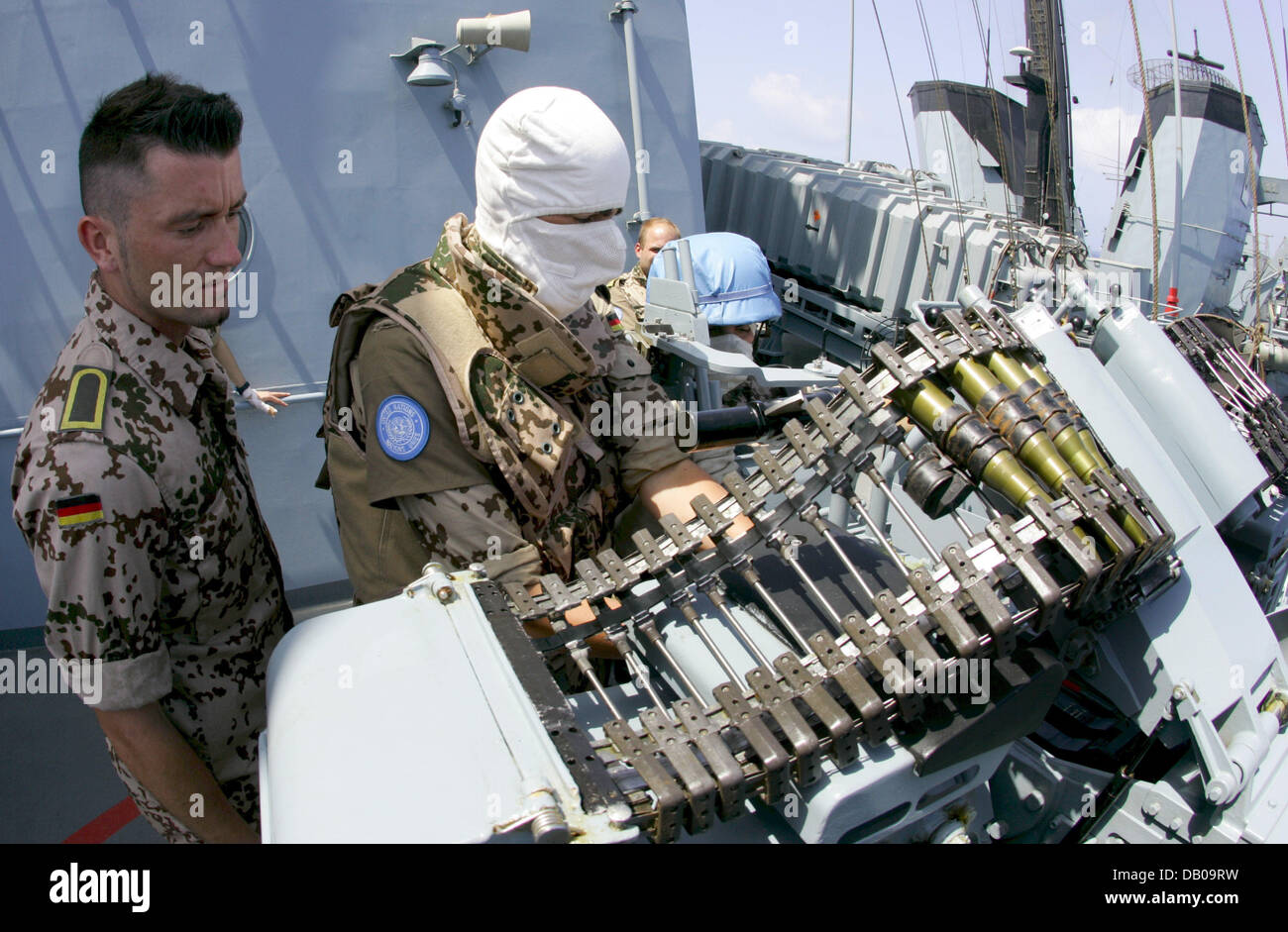 German Navy soldiers are trained on a gun on frigate 'Schleswig ...